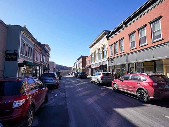 Mountains frame this Main Street where painted storefronts add splashes of personality to classic New England architecture.