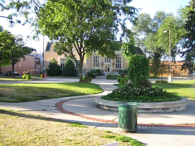 Peaceful pathways wind through green spaces where families stroll and kids play under the shade of mature trees.