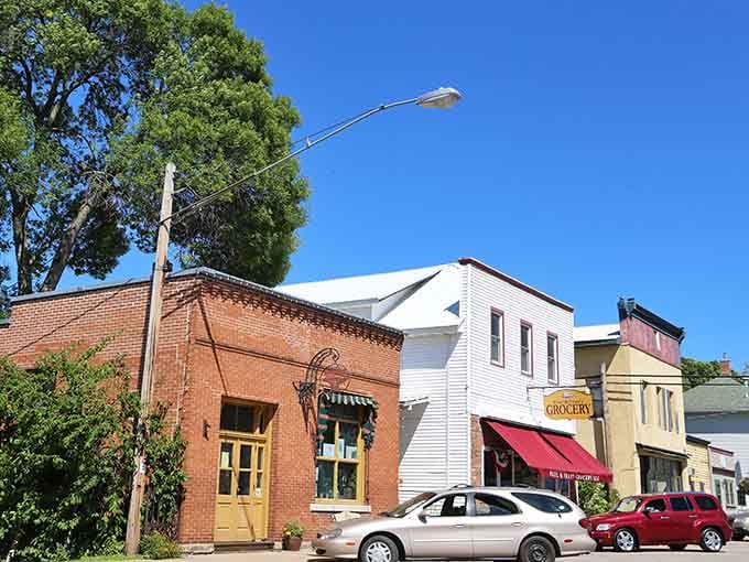 Brick storefronts wear their history with pride, standing firm against time like old friends who never leave.