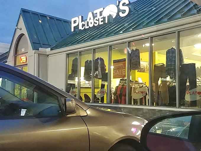 Evening shopping under those warm lights transforms thrifting into an adventure, with stylish finds visible through those welcoming windows.