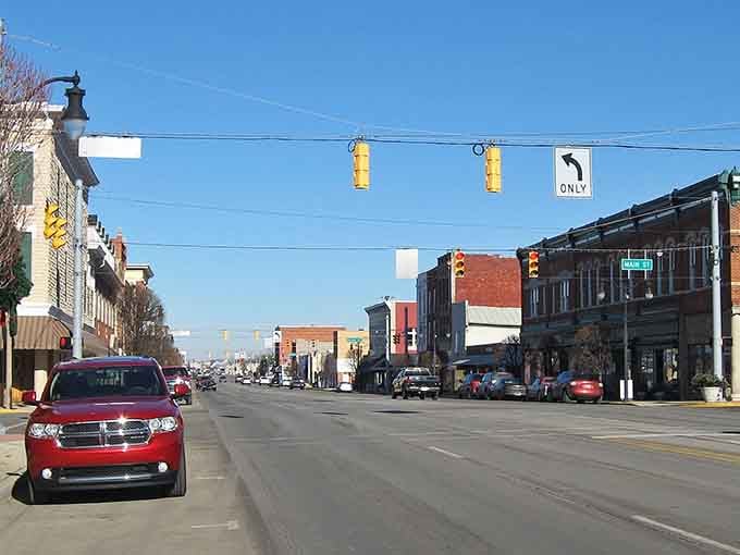 Traffic lights dangle over a peaceful downtown where rush hour means waiting for maybe three cars to pass.