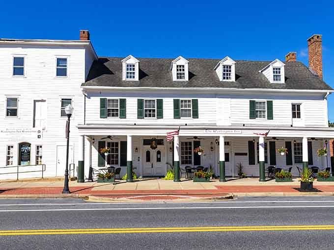 Colonial architecture welcomes visitors with green shutters and hanging baskets, proving elegance doesn't require excessive spending.