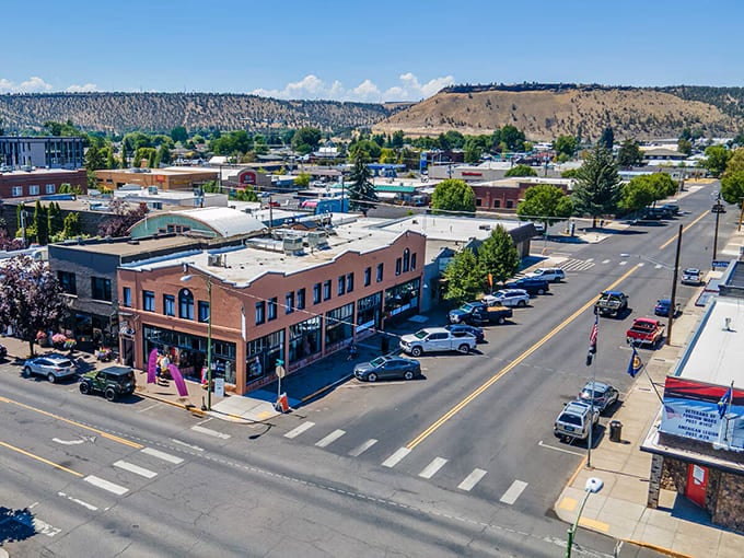 Bird's-eye view reveals a town cradled by hills, where community and landscape blend in perfect harmony.