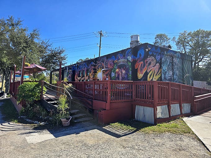 A wooden deck welcomes you to The Butt Hutt, where serious barbecue hides behind a playful name and artistic facade.