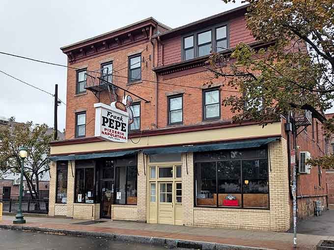 That classic brick facade has witnessed more pizza pilgrimages than most buildings see in ten lifetimes of operation.