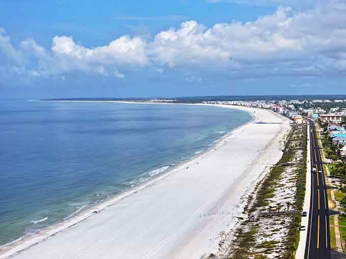 That pristine white sand stretches for miles like nature's own welcome mat to paradise, untouched and gloriously uncrowded.
