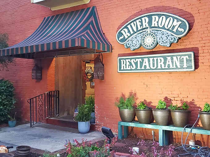 That coral-colored entrance welcomes you like an old friend, complete with potted plants that somehow look happier than most people on Monday mornings.