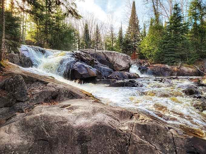 Water rushing over ancient boulders like nature's own obstacle course, minus the participation trophy at the end.