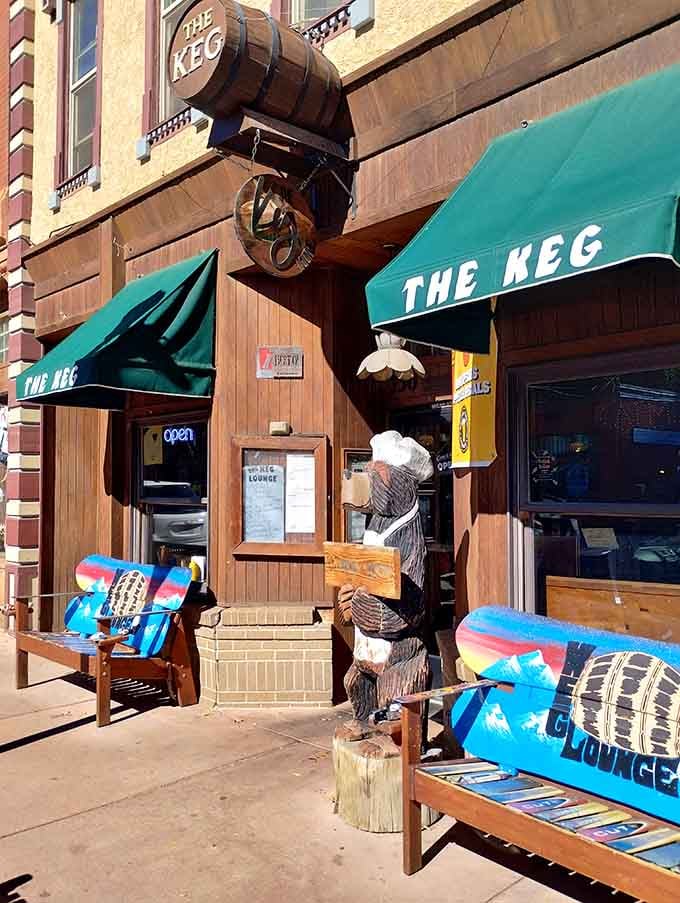 That wooden bear and those colorful benches are basically Manitou Springs saying hello before you even walk inside.