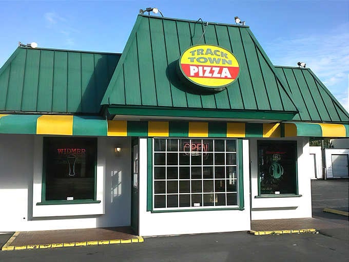 That cheerful green roof and sunny yellow awning practically wave you down from the street like an old friend.