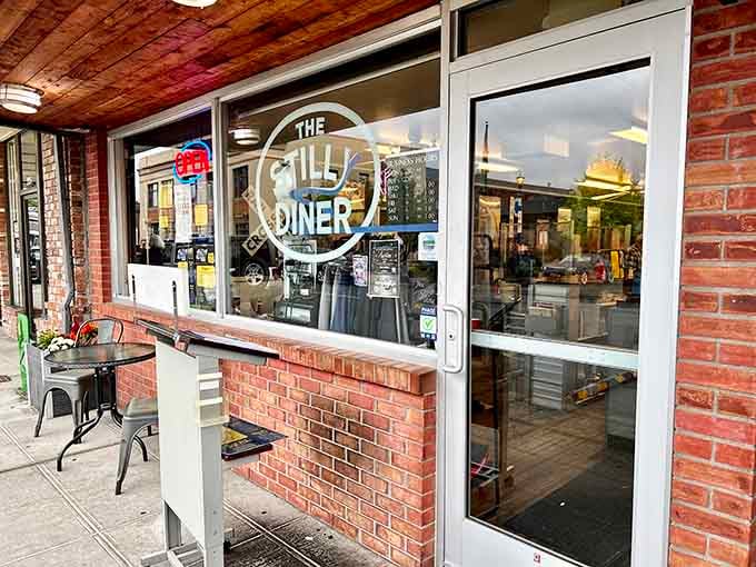 That classic storefront with the brick base and cheerful planters says "come on in" louder than any neon sign ever could.