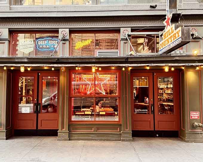 That glowing neon sign isn't just advertising, it's a beacon calling you home to smoked meat paradise.