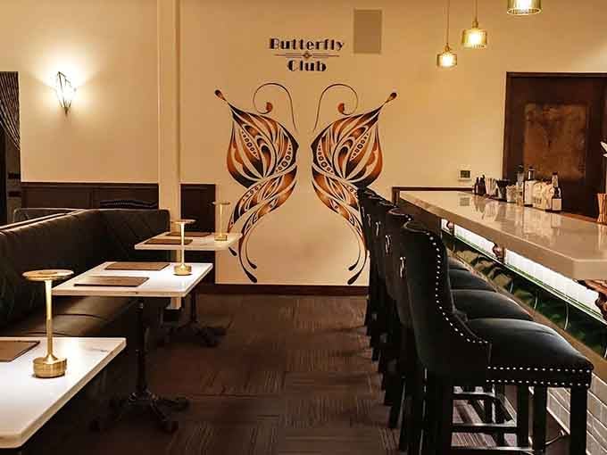 Those butterfly wings on the wall aren't just decoration, they're basically telling you to spread your own wings and order dessert.