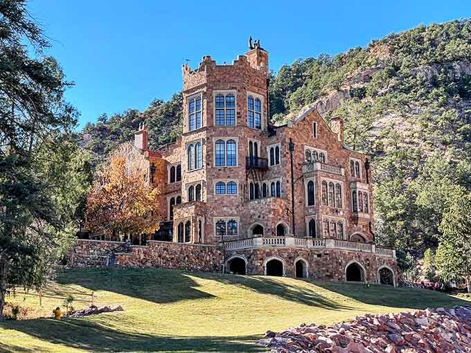 That first glimpse of Glen Eyrie's red sandstone towers rising from the Colorado landscape is pure storybook magic.