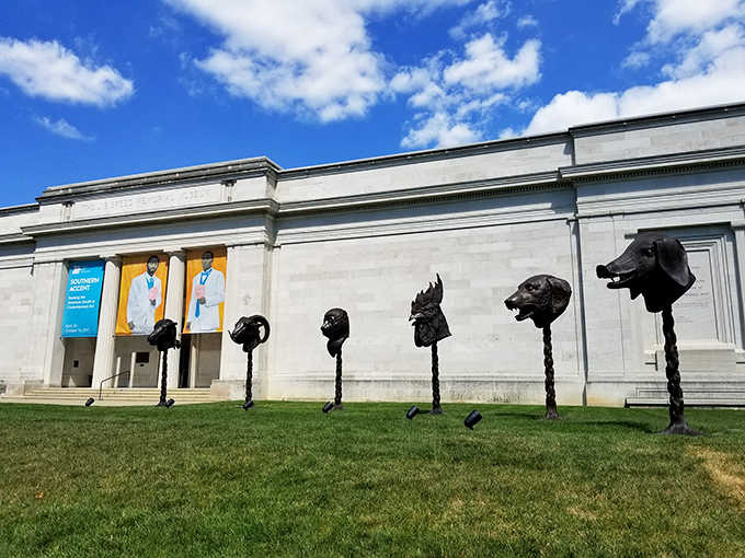 Those mysterious dog heads on poles outside aren't guarding secrets, they're inviting you into artistic wonderland.