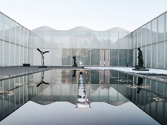 Winter transforms the reflecting pool into a mirror world where reality doubles back on itself beautifully.