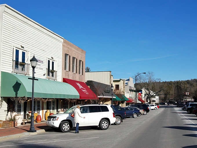 Those colorful awnings and mountain backdrop create the kind of scene that makes postcards jealous of real life.