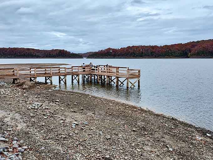 That wooden fishing pier stretching into autumn-kissed waters is your gateway to Kentucky's most peaceful escape.