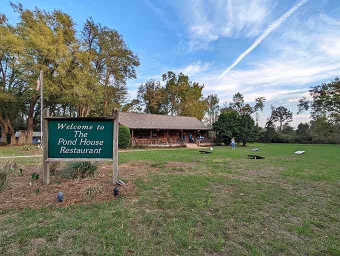That welcoming sign and rustic lodge nestled among towering trees promises the kind of meal worth every bumpy mile.