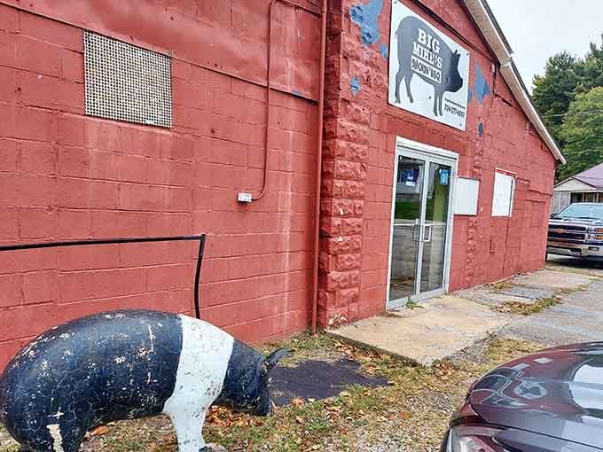 That cheerful pig statue greeting you outside tells you everything: this place takes its barbecue seriously but itself not so much.