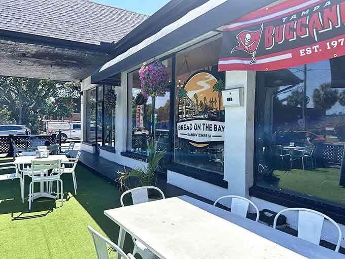 That vibrant green turf and cheerful patio setup practically scream "Florida mornings done right" from the sidewalk.