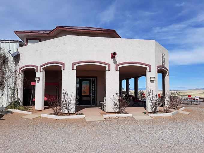 The welcoming entrance with its Southwestern architecture beckons wine enthusiasts into Arizona's pioneering vineyard like a desert mirage made real.