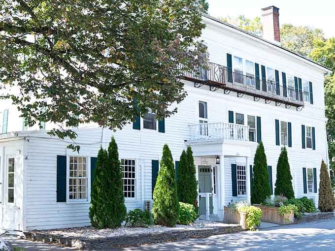 Those perfectly trimmed evergreens aren't just landscaping, they're sentries guarding centuries of New England architectural elegance.