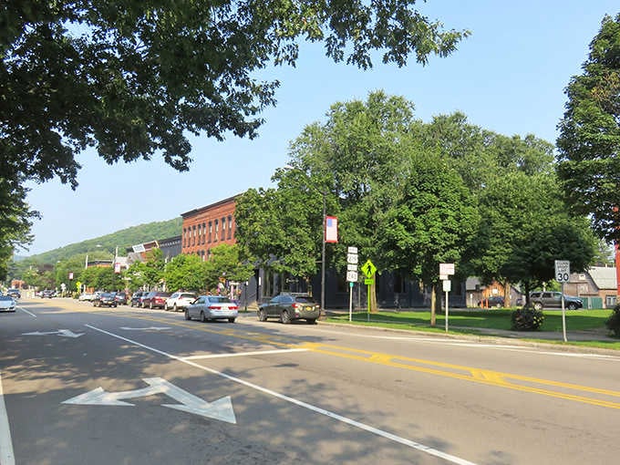 Historic brick buildings frame a main street where parking spots outnumber your daily stress levels by miles.