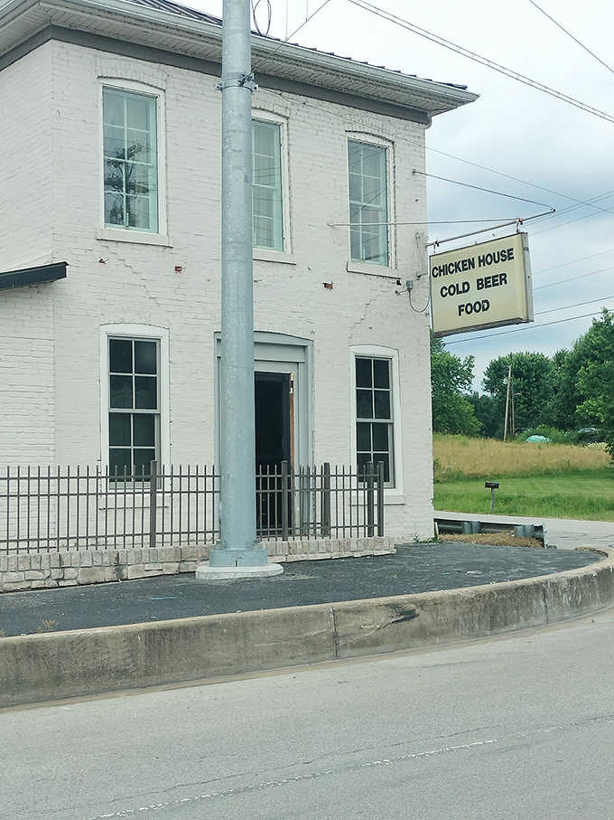 That historic white brick building with the simple "Chicken House Cold Beer Food" sign is your destination for fried chicken glory.