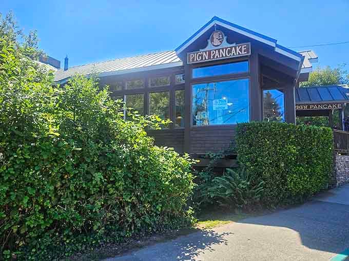 The wood-shingled exterior practically whispers "come in for pancakes" while that lush greenery says "we've been here long enough to earn our stripes."