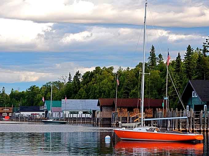 That orange sailboat has seen more peaceful mornings than most of us will experience in a lifetime.