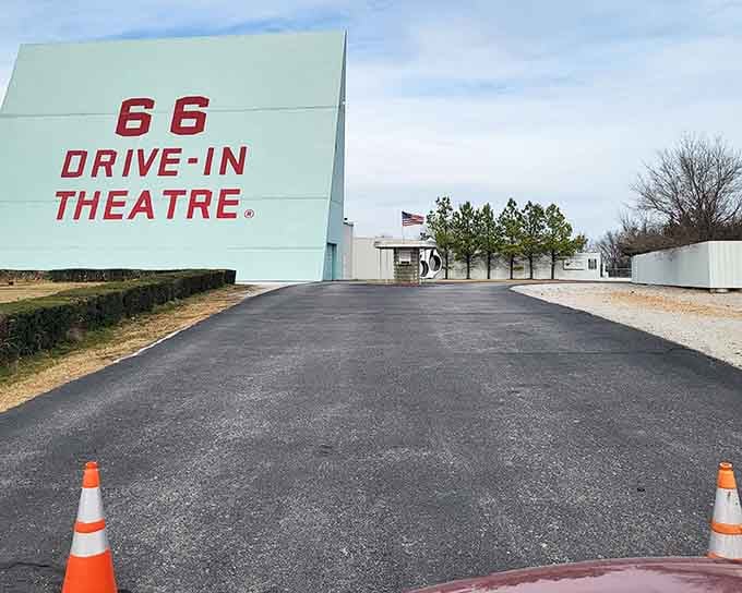 That towering sign and fresh asphalt welcome you to an evening where nostalgia meets modern moviegoing magic.