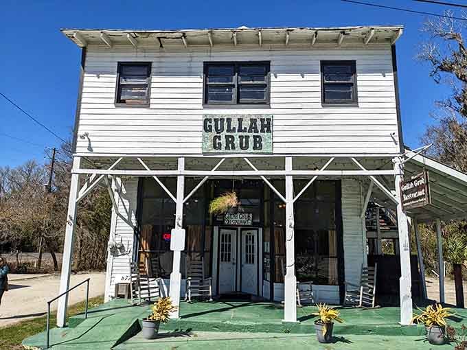 That white clapboard exterior with the green porch isn't just charming, it's practically begging you to sit and stay awhile.