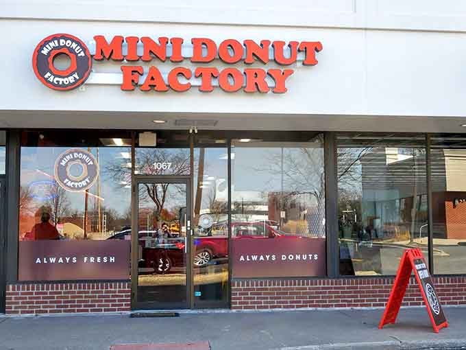 That bright orange signage isn't just decoration, it's a promise of warm, fresh donuts waiting inside for you.