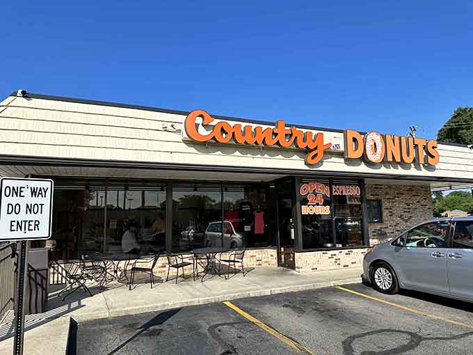 That classic orange signage isn't just decoration, it's a beacon calling all who worship at the altar of donuts.