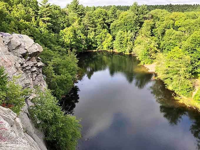 Cliffside views overlook a tree-lined river at Freetown-Fall River State Forest in Massachusetts, perfect for quiet escapes into nature.