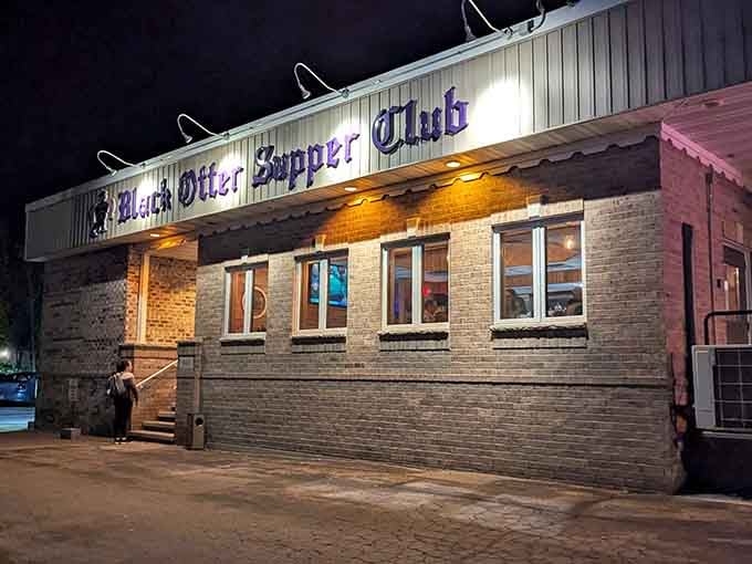 Black Otter Supper Club exterior at night, glowing with the promise of perfectly cooked steaks and classic cocktails.