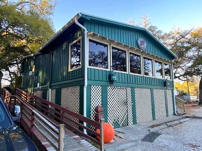 That teal-green exterior isn't trying to hide from anyone, perched right on the water's edge like a coastal beacon.