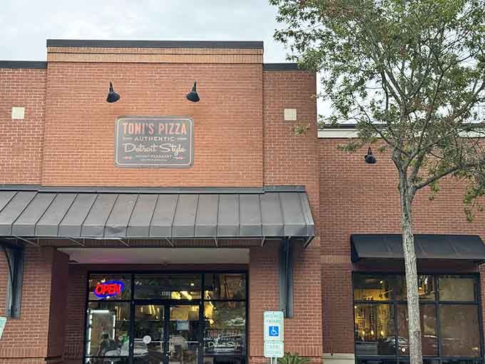 That unassuming brick exterior is hiding some serious pizza magic, like Clark Kent in a phone booth.