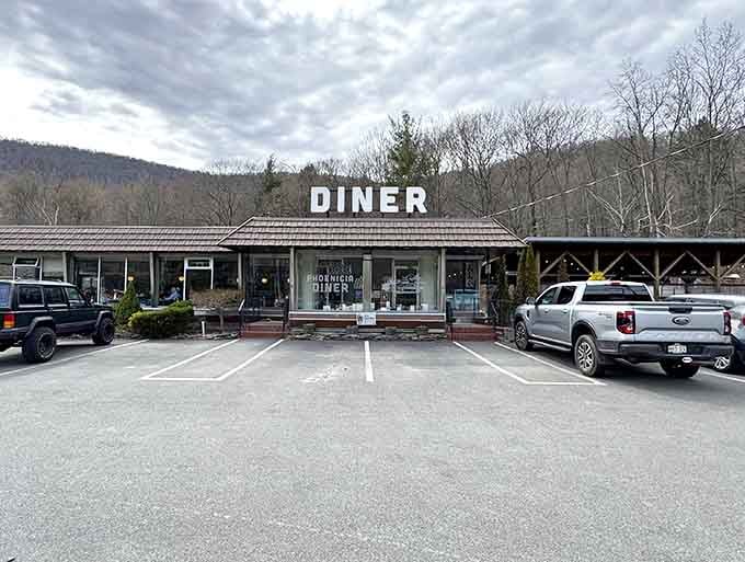 Classic diner exterior with mountains rising behind it, looking exactly like what road trip dreams are made of.