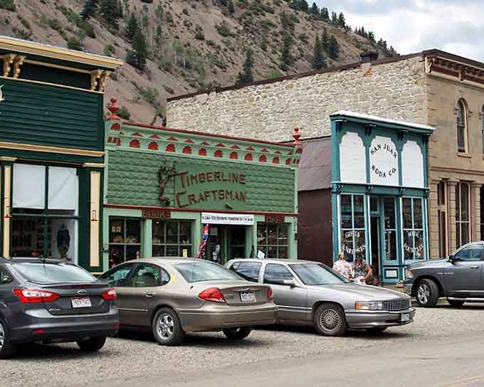 These colorful storefronts against rugged mountain slopes prove that the Old West had better taste than most modern strip malls.