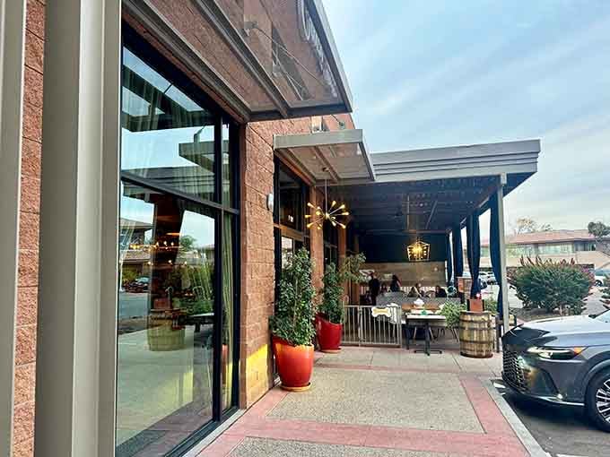 The entrance whispers sophistication while the patio beckons with promises of Italian indulgence and hidden cocktail adventures ahead.