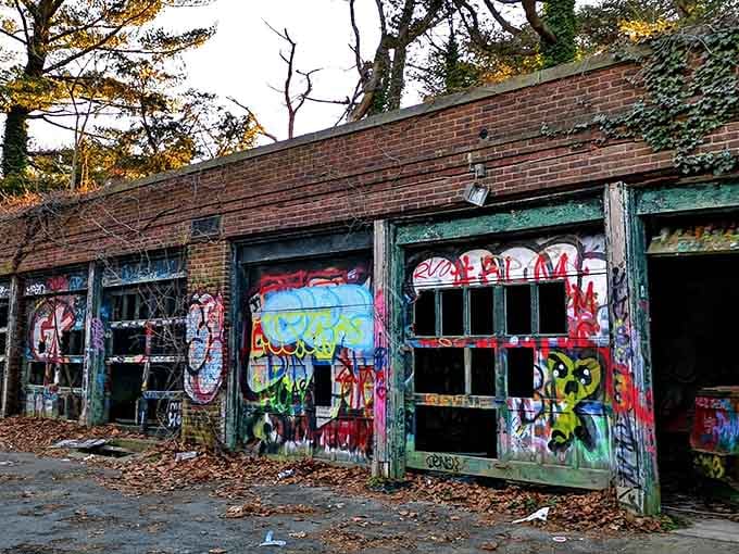 These weathered brick structures wear their graffiti like badges of honor, each layer telling a different story through time.