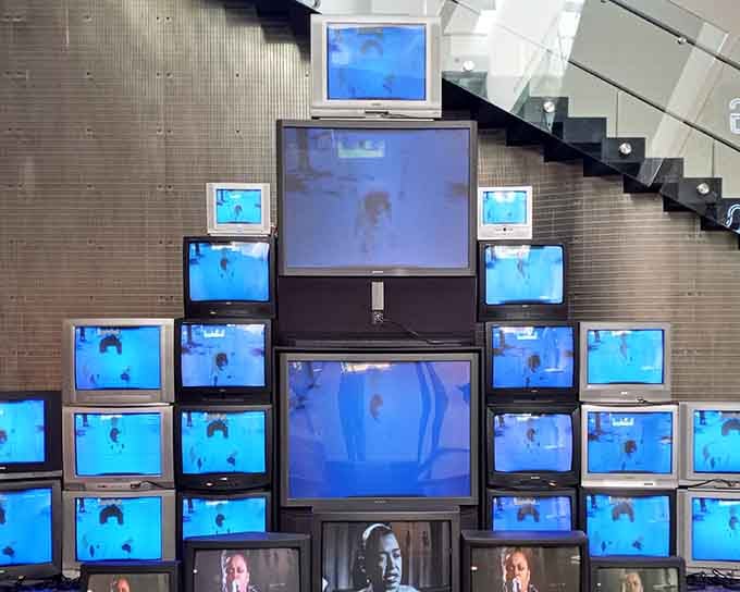 When dozens of screens show you from every angle, you realize art has been watching you back all along.