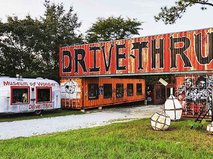 That towering red sign announces you've arrived somewhere wonderfully weird, where art meets Americana roadside charm.