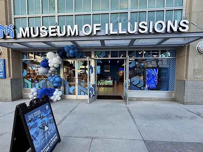 The Museum of Illusions storefront beckons with promises to scramble your brain like Sunday morning eggs.