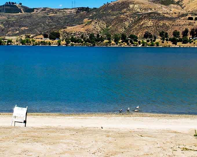 That turquoise water looks like someone dropped a giant sapphire in the middle of golden California hills.