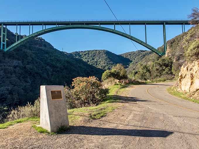 The Cold Spring Canyon Bridge arches gracefully overhead like a concrete rainbow connecting two mountain ridges perfectly.