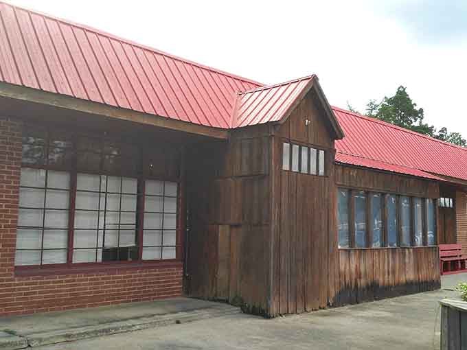 That red metal roof and weathered wood exterior tells you everything: real food happens here, no fancy facades needed.
