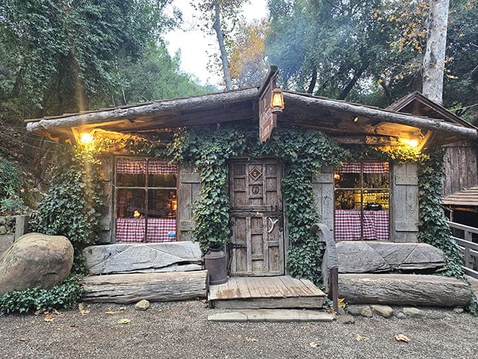 Ivy-draped logs and weathered wood create an entrance that looks plucked straight from a frontier fantasy.